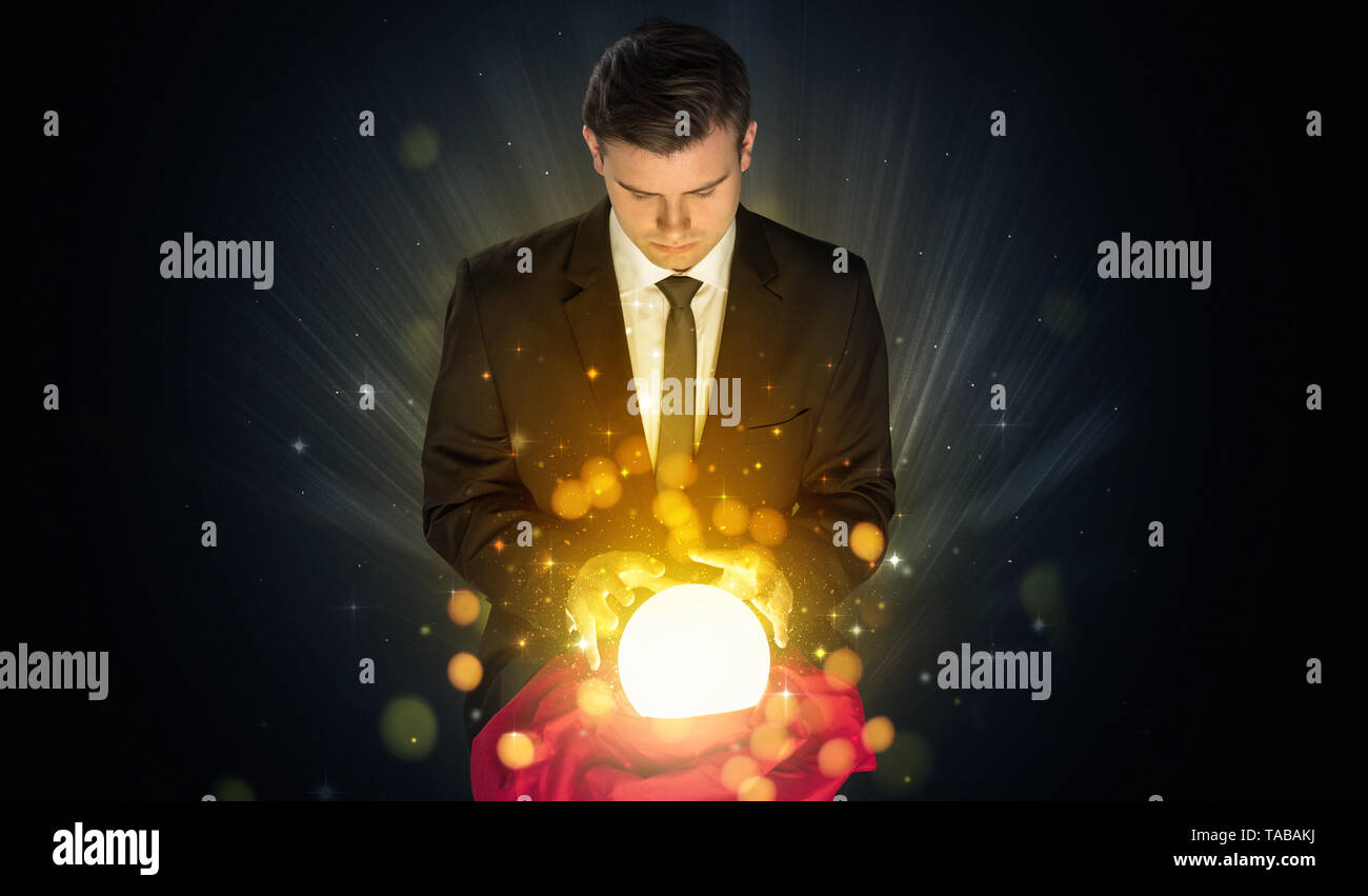 Gorgeous businessman sitting with sparkling magic ball in his lap Stock ...