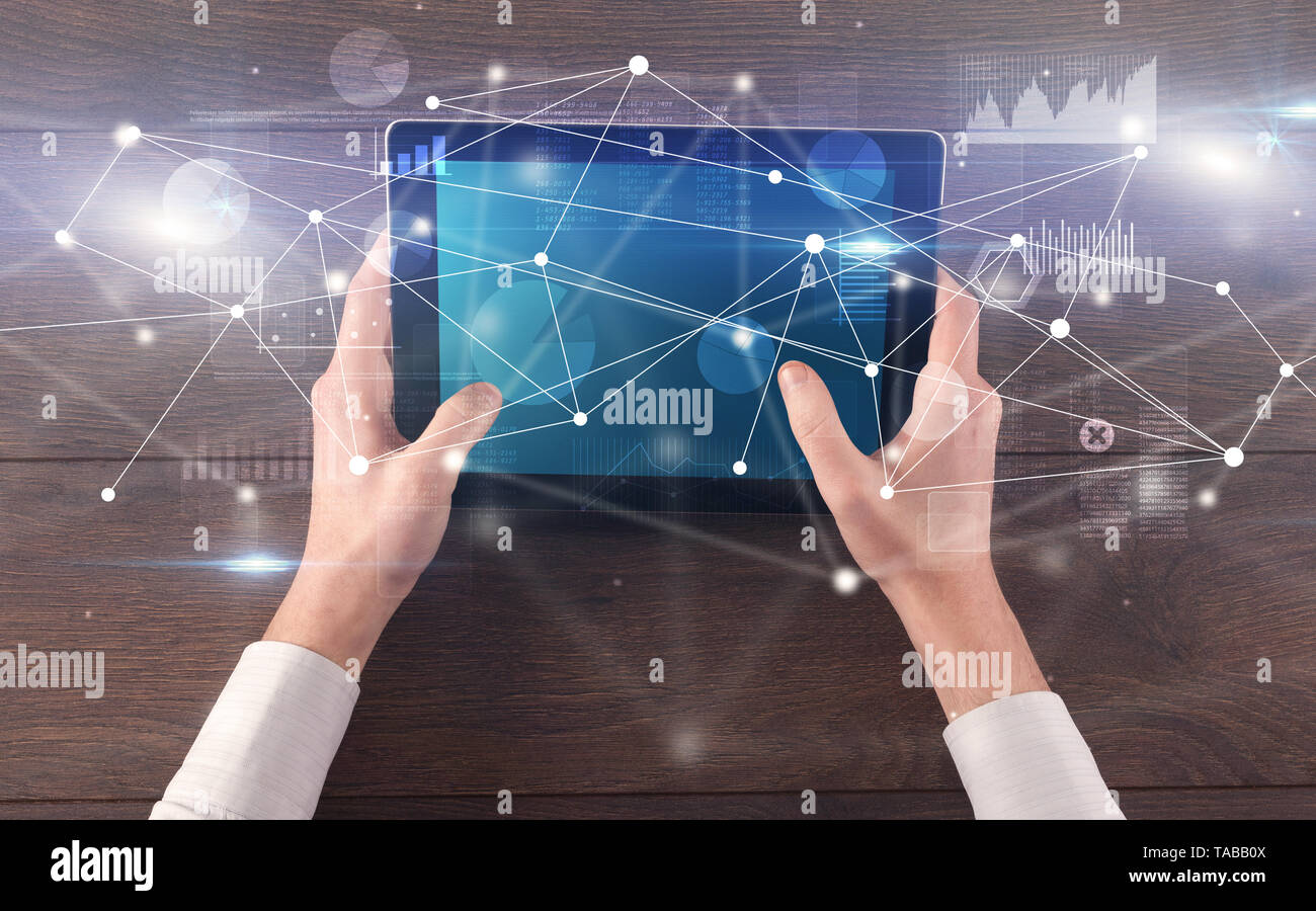 Hand using tablet with linking graphs charts report and informational ...