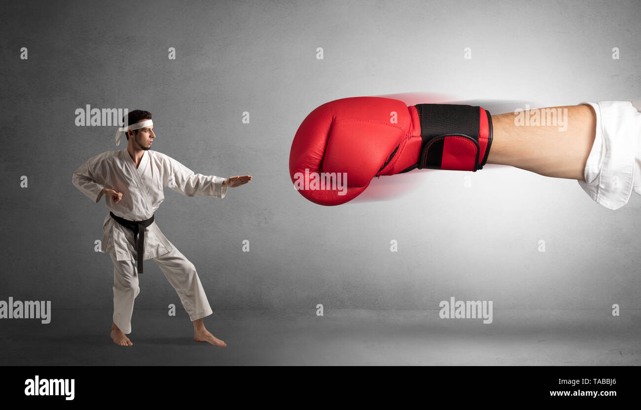Little man fighting with a giant red boxing glove Stock Photo - Alamy