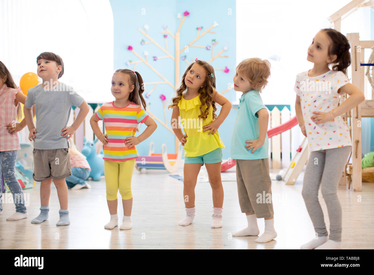 Group of children are engaged indoor physical exercise Stock Photo - Alamy