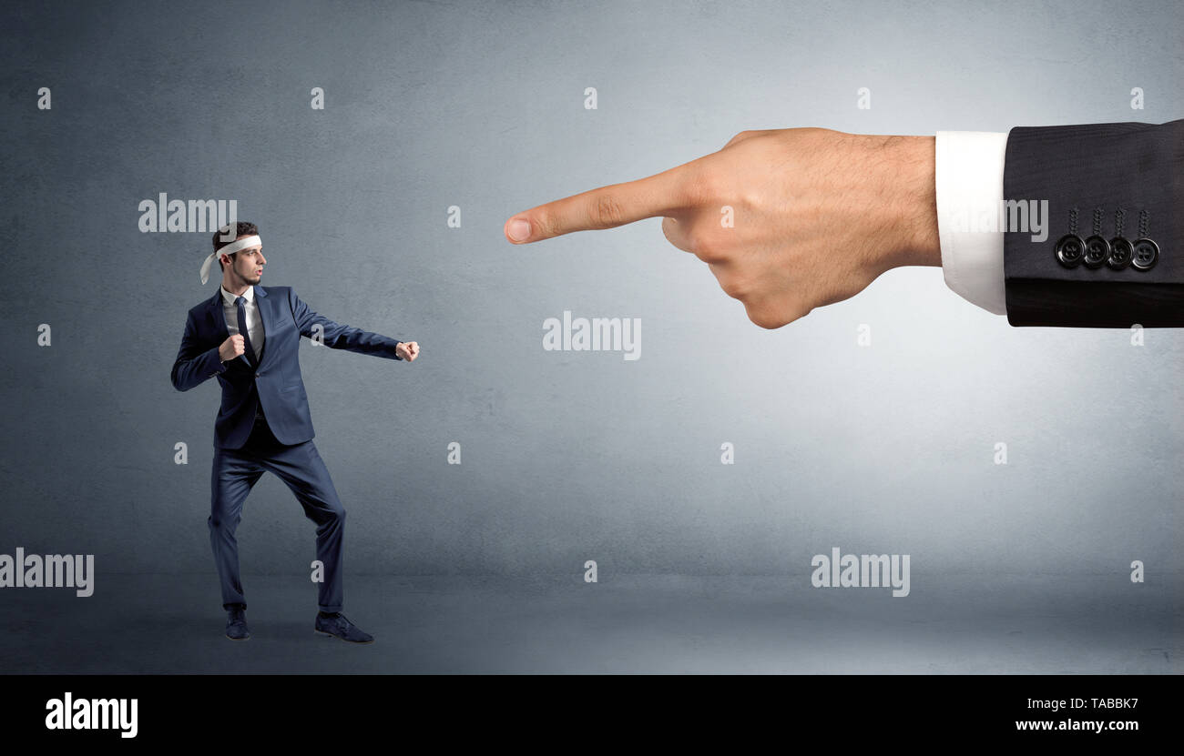 Small karate man fighting with big hand Stock Photo - Alamy