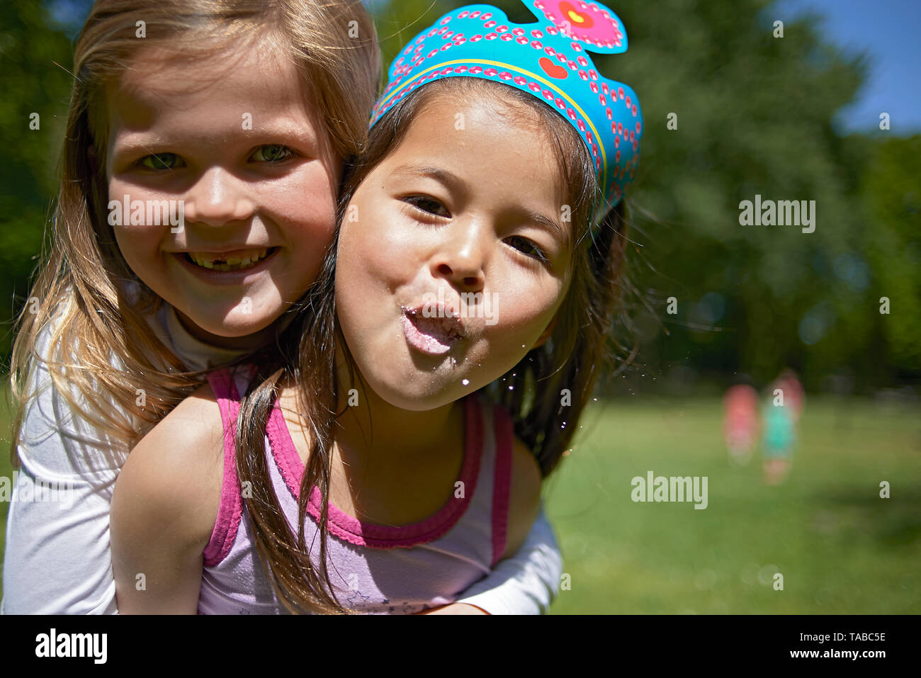 Smiling girls hugging birthday party hi-res stock photography and ...