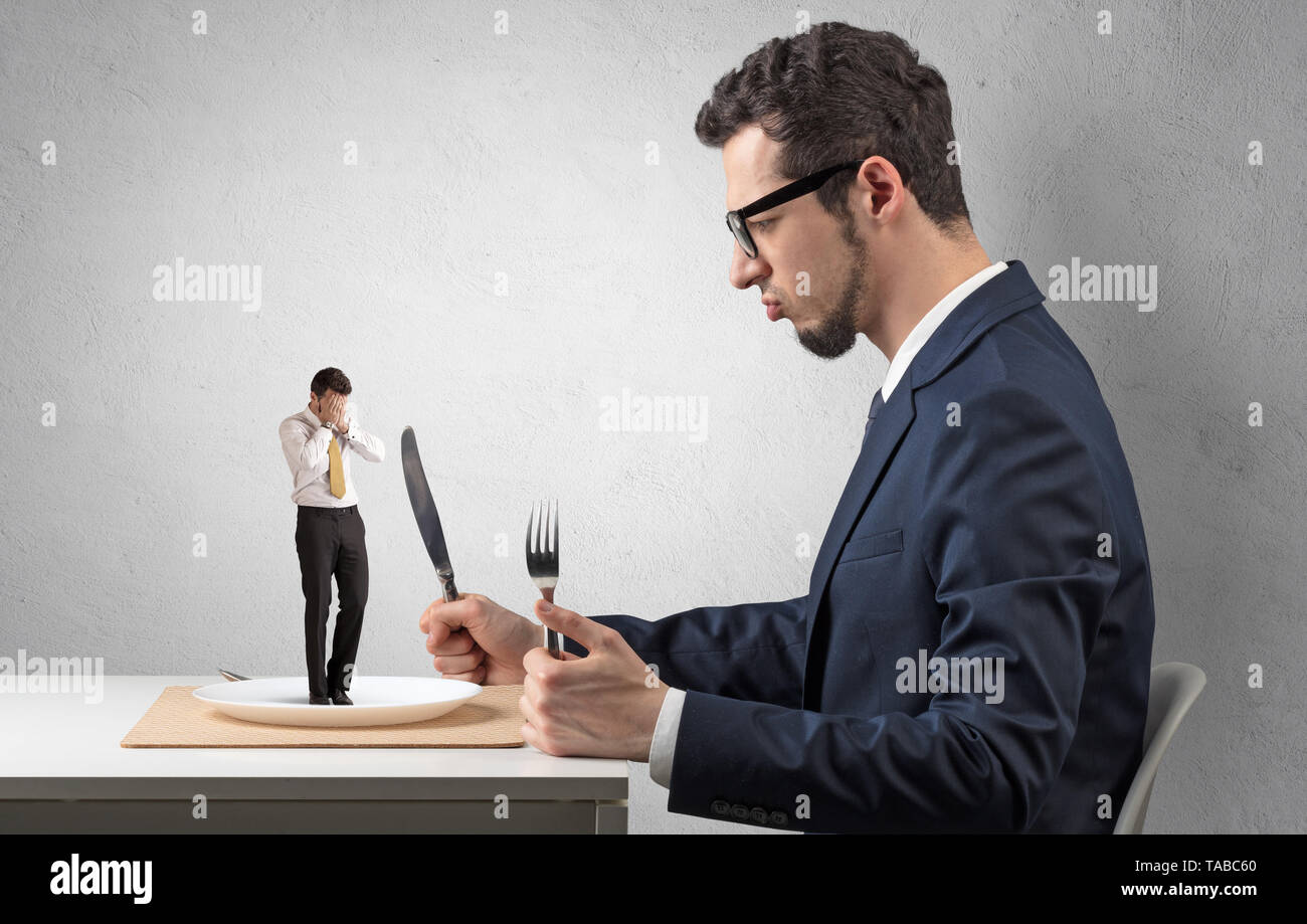 Tiny scared weak businessman almost devoured by great power Stock Photo ...