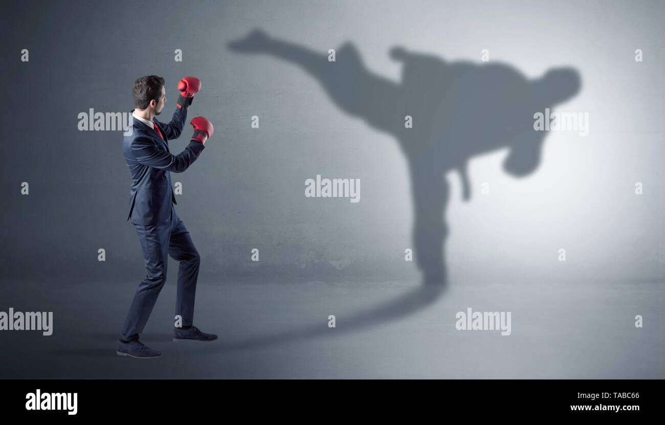 Businessman fighting with his strong karate man shadow Stock Photo - Alamy