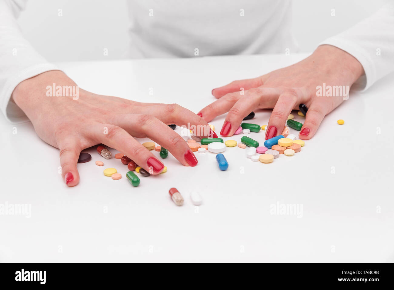 Beautiful female hand holds pill gesture Stock Photo - Alamy