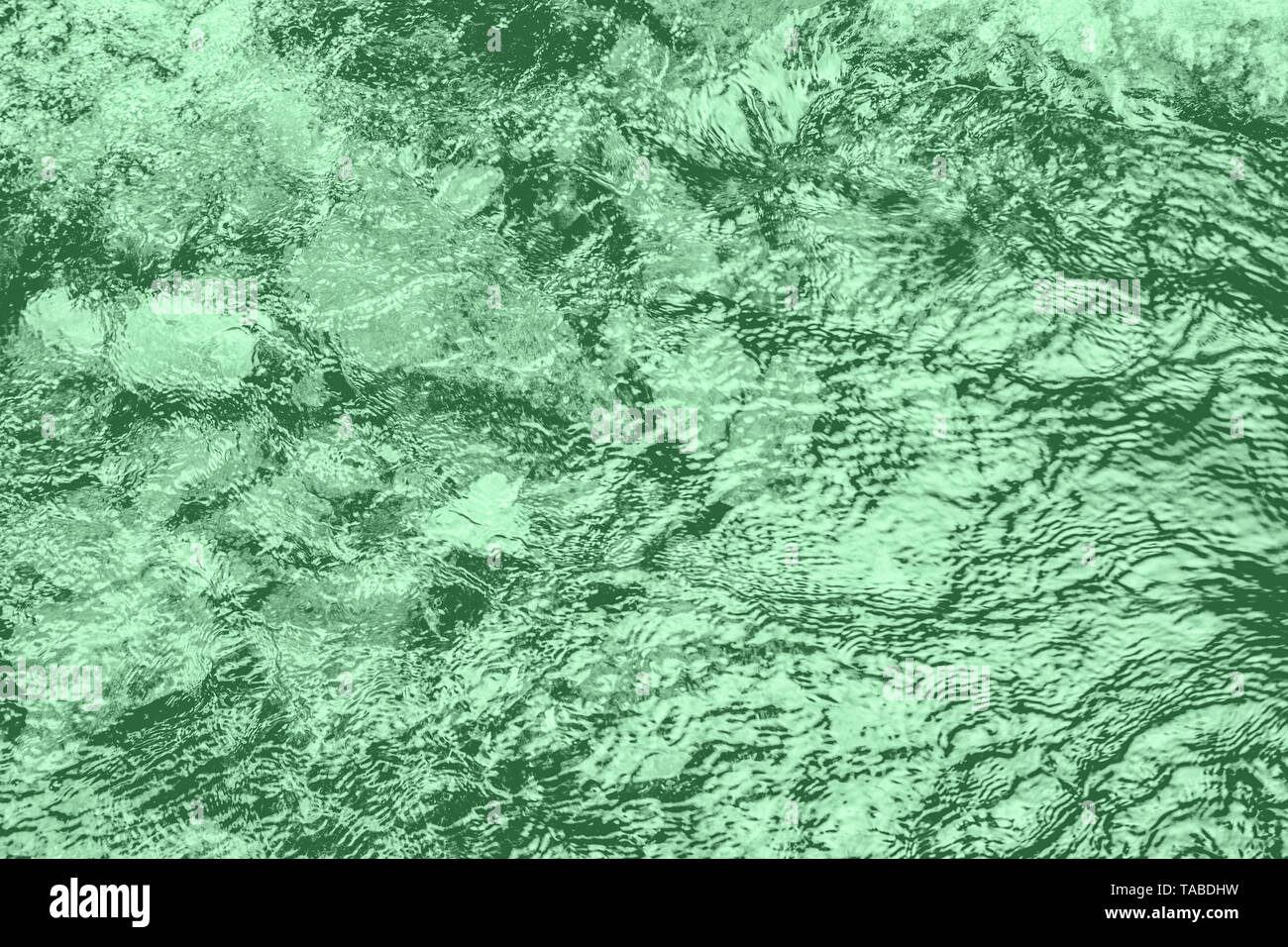 Closeup of rough river water surface with water splashes in neo mint ...