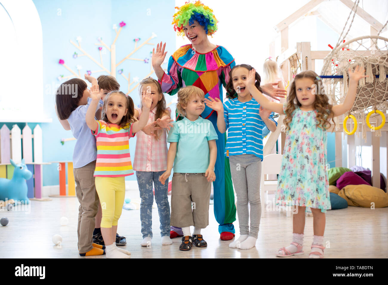 children group with clown celebrating birthday party in daycare Stock ...