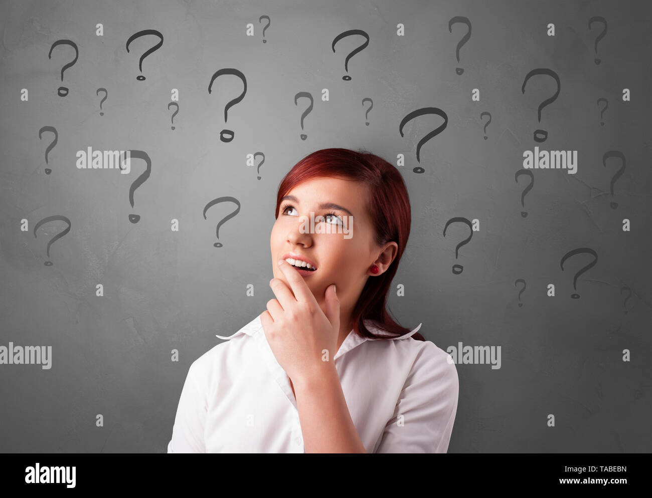 Person with question marks around face Stock Photo - Alamy