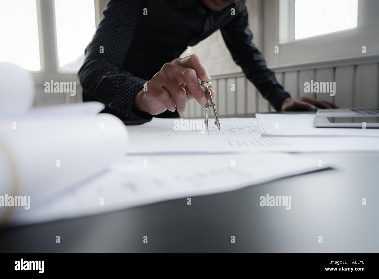 architect engineer working on house blueprint of real estate project at workplace. building ...