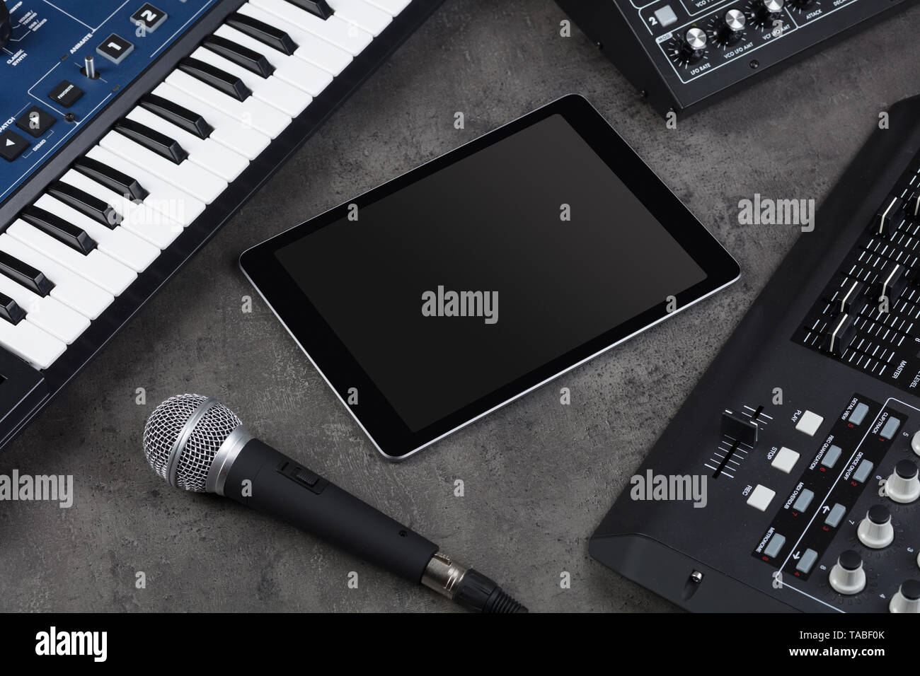 Empty tablet and electronic music instruments Stock Photo - Alamy