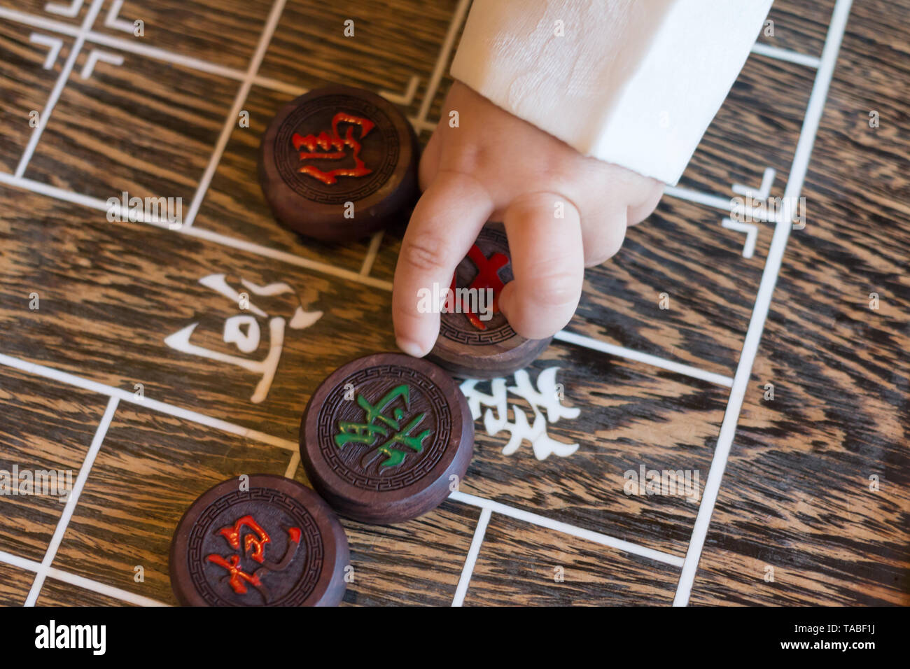 baby hand playing chinese chess. The chinese character on marker ...