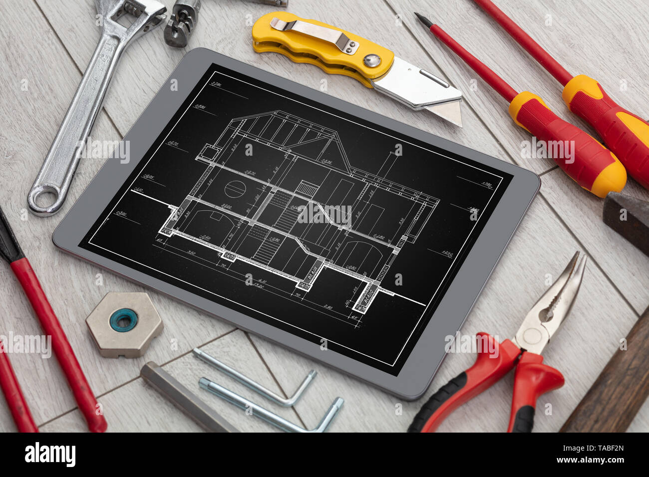 Tablet with construction tools and blueprint concept Stock Photo - Alamy