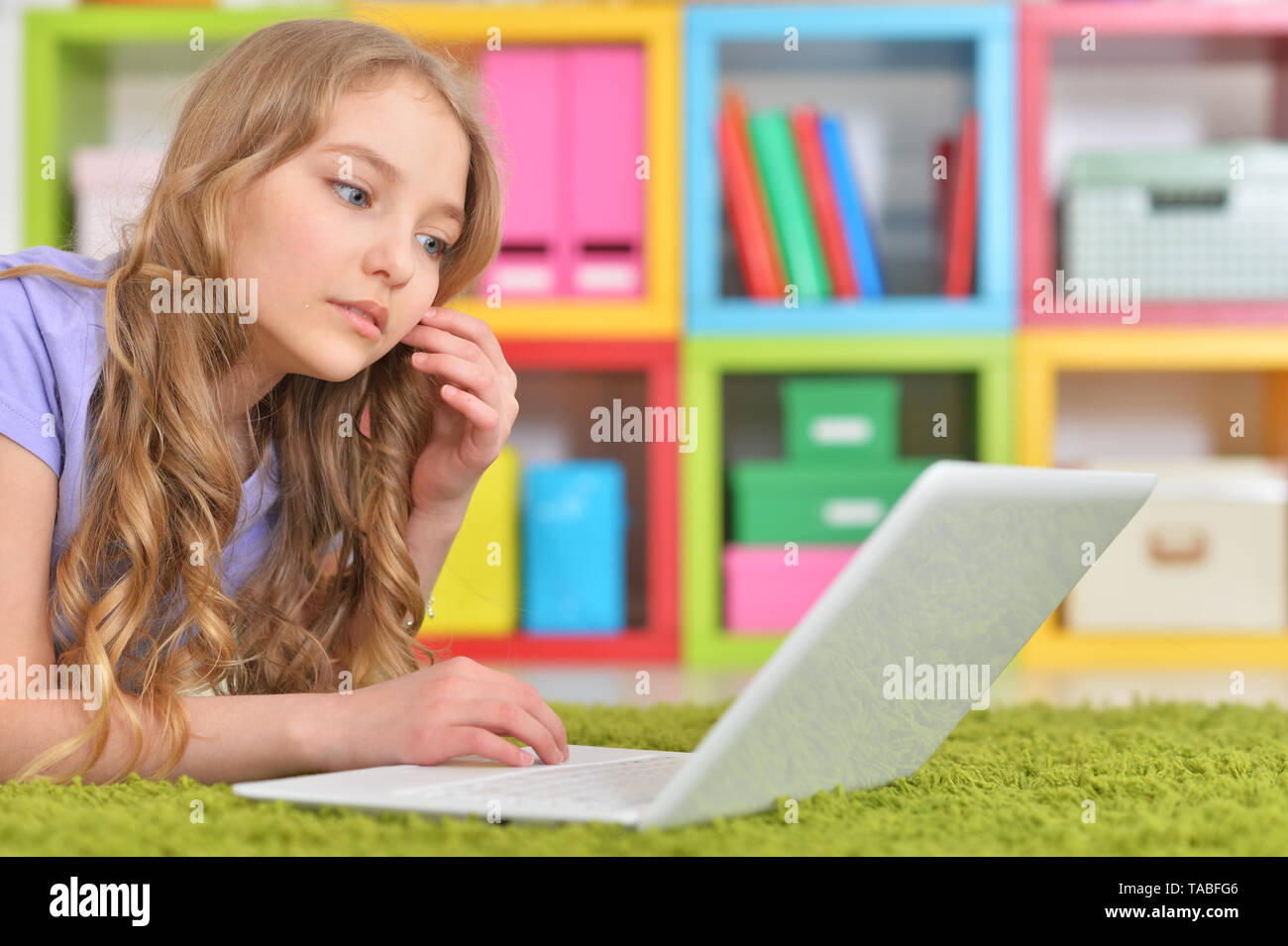 Portrait of emotional cute girl using laptop Stock Photo - Alamy