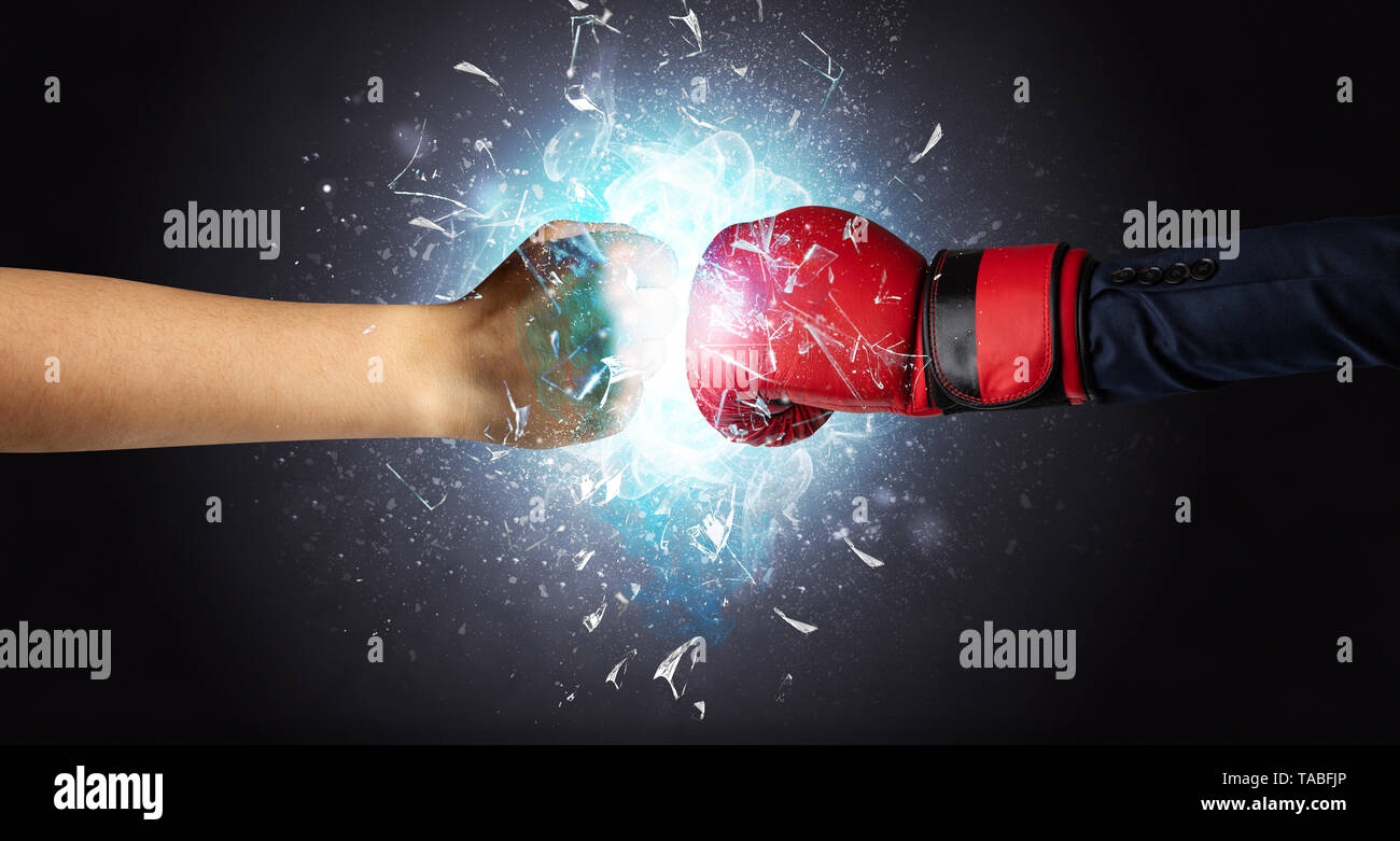 Two hands fighting and breaking glass into small pieces with blue light ...