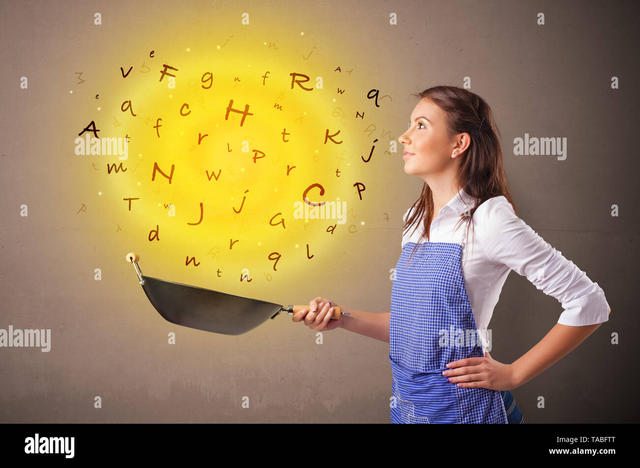 Young person cooking letters in wok Stock Photo - Alamy