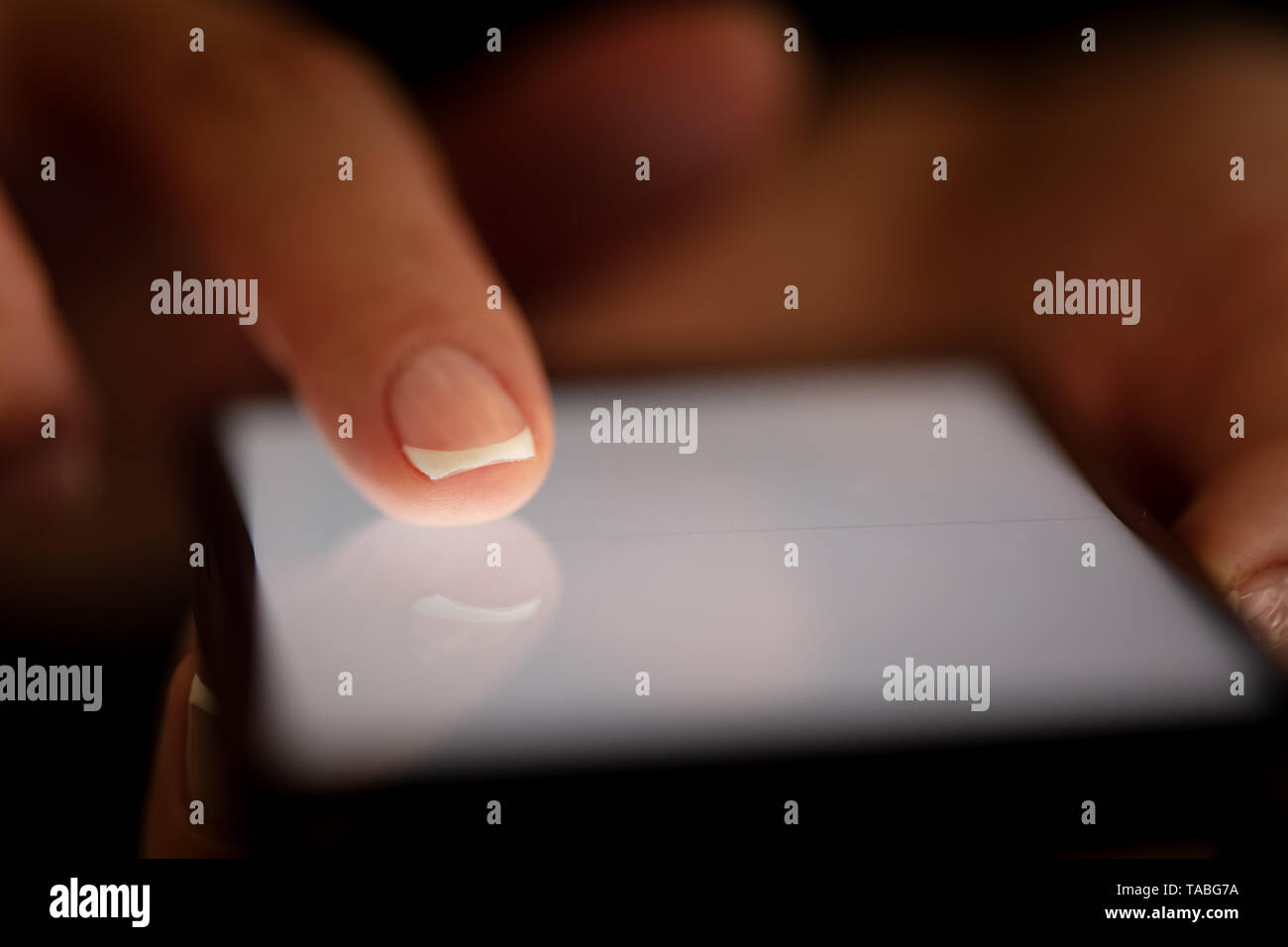 Finger touching phone with dark background with copyspace Stock Photo ...