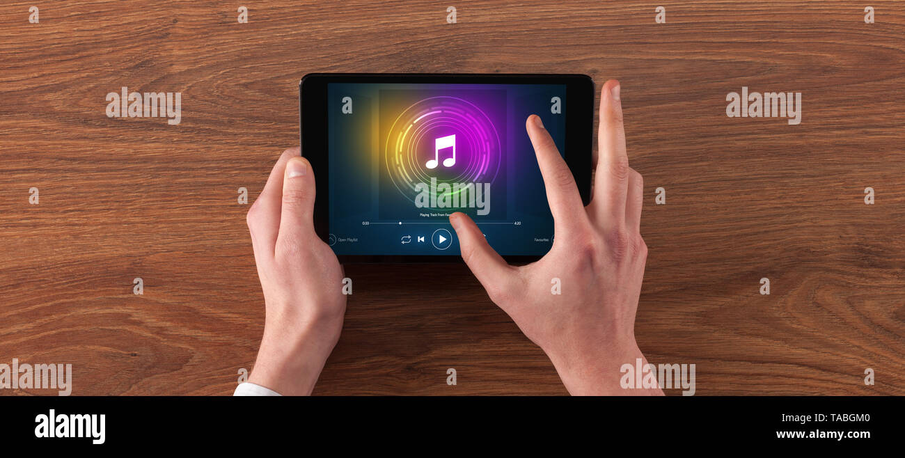 Hand touching tablet with music play concept Stock Photo - Alamy