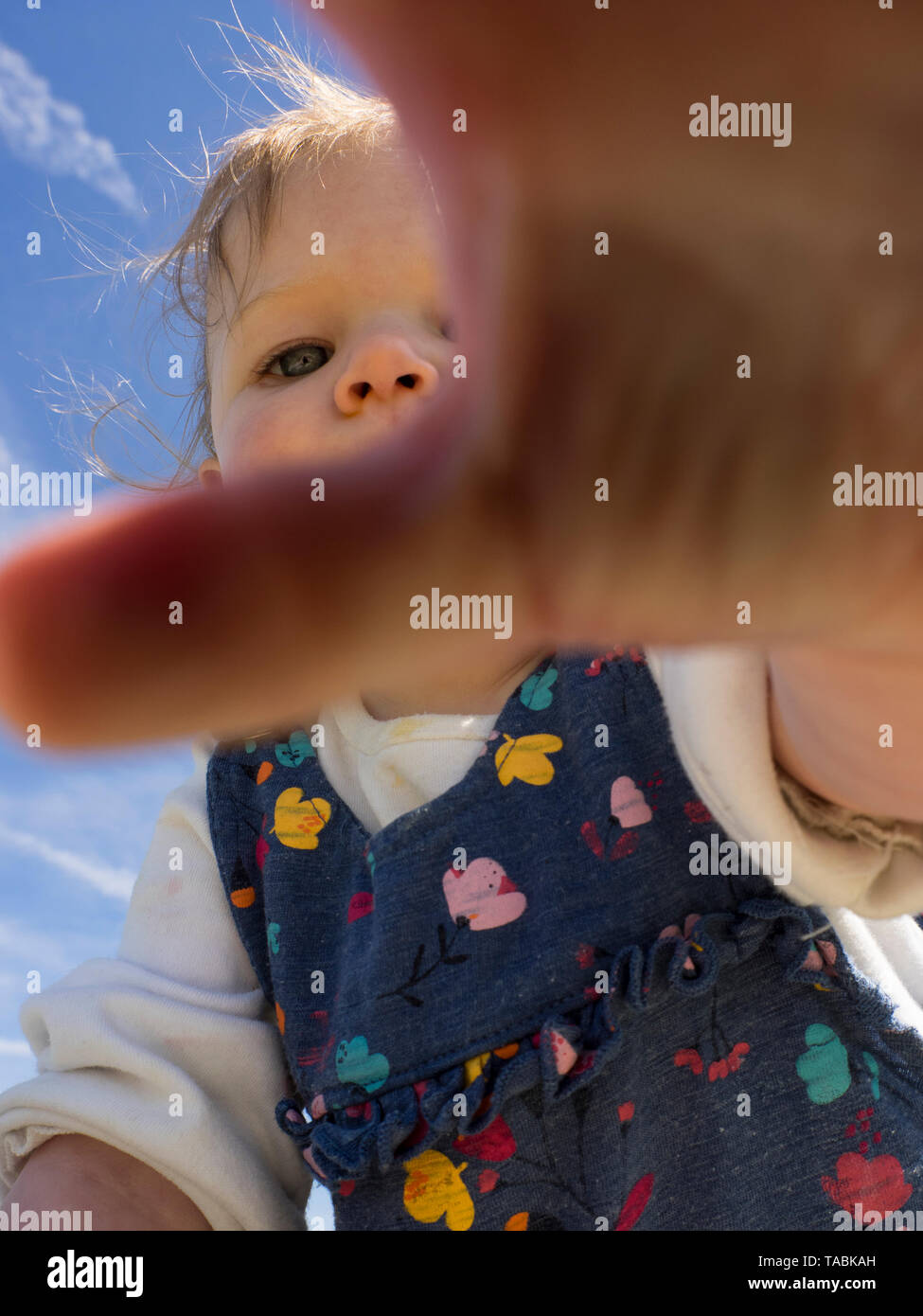 Baby reaching for the camera Stock Photo - Alamy