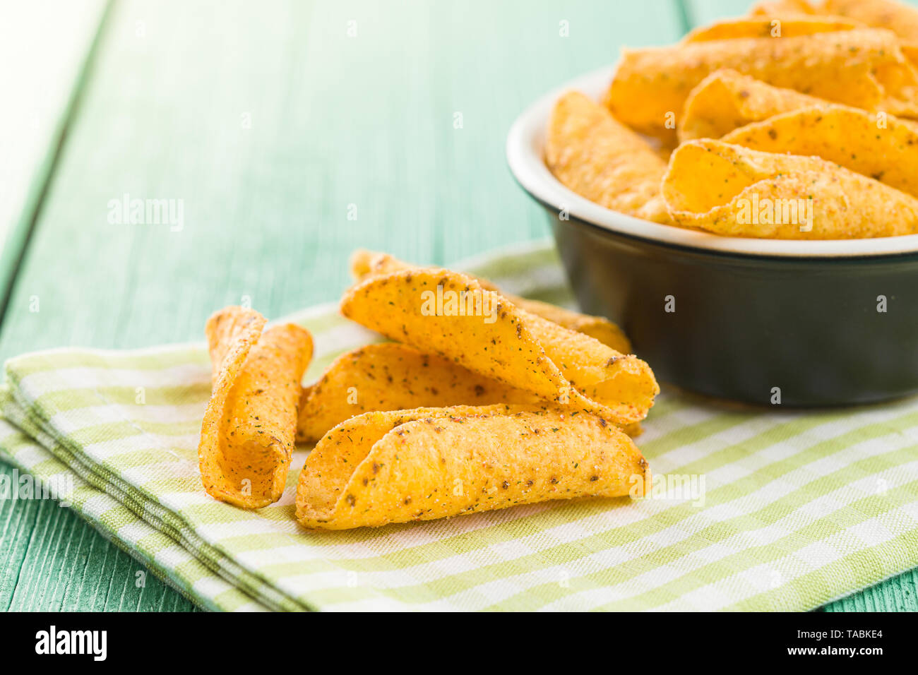 Rolled tortilla chips on checkered napkin Stock Photo - Alamy