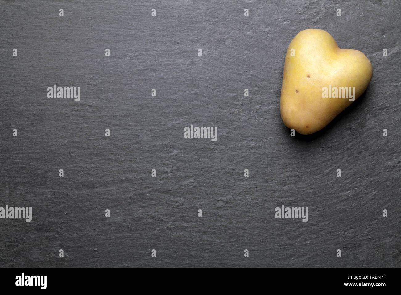 heart potato with a black graphite background Stock Photo - Alamy
