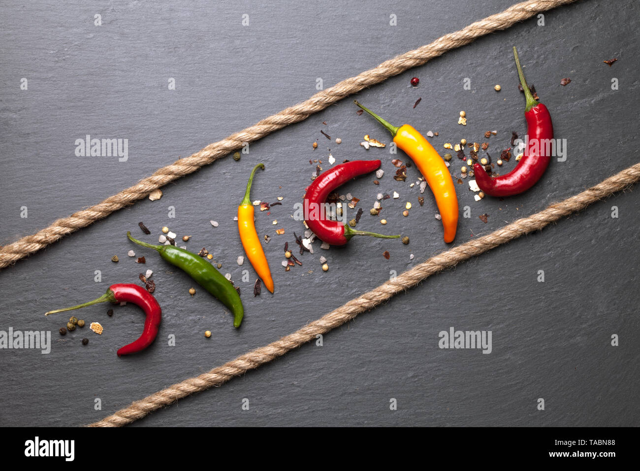 colorful chili peppers with a rope Stock Photo - Alamy