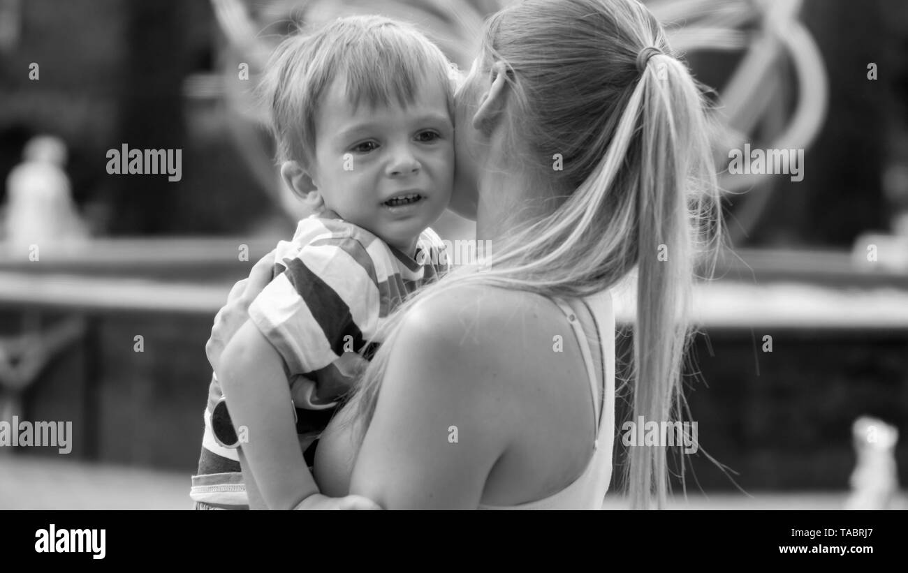 Black and white portrait of crying 3 years old toddler boy hugging his ...