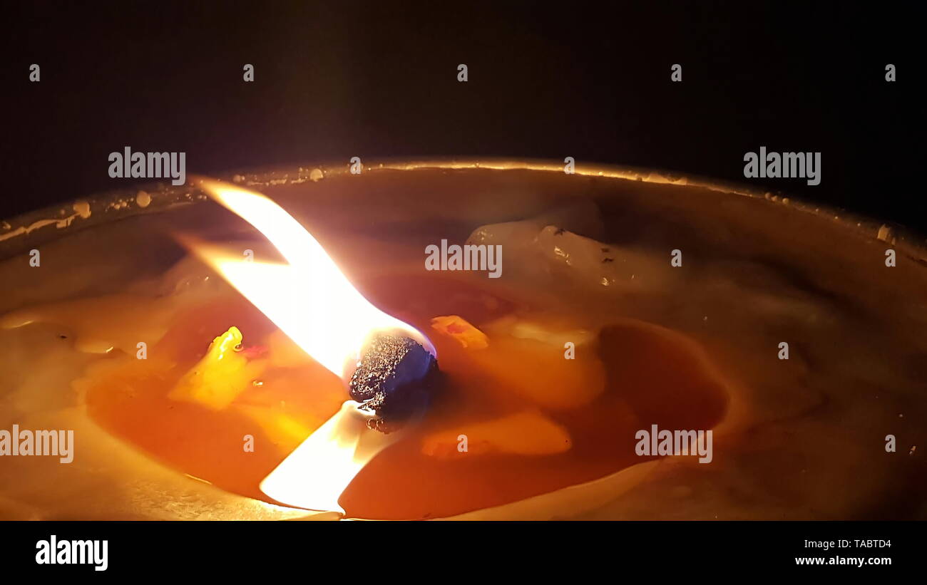 Burning candle made of wax Stock Photo - Alamy