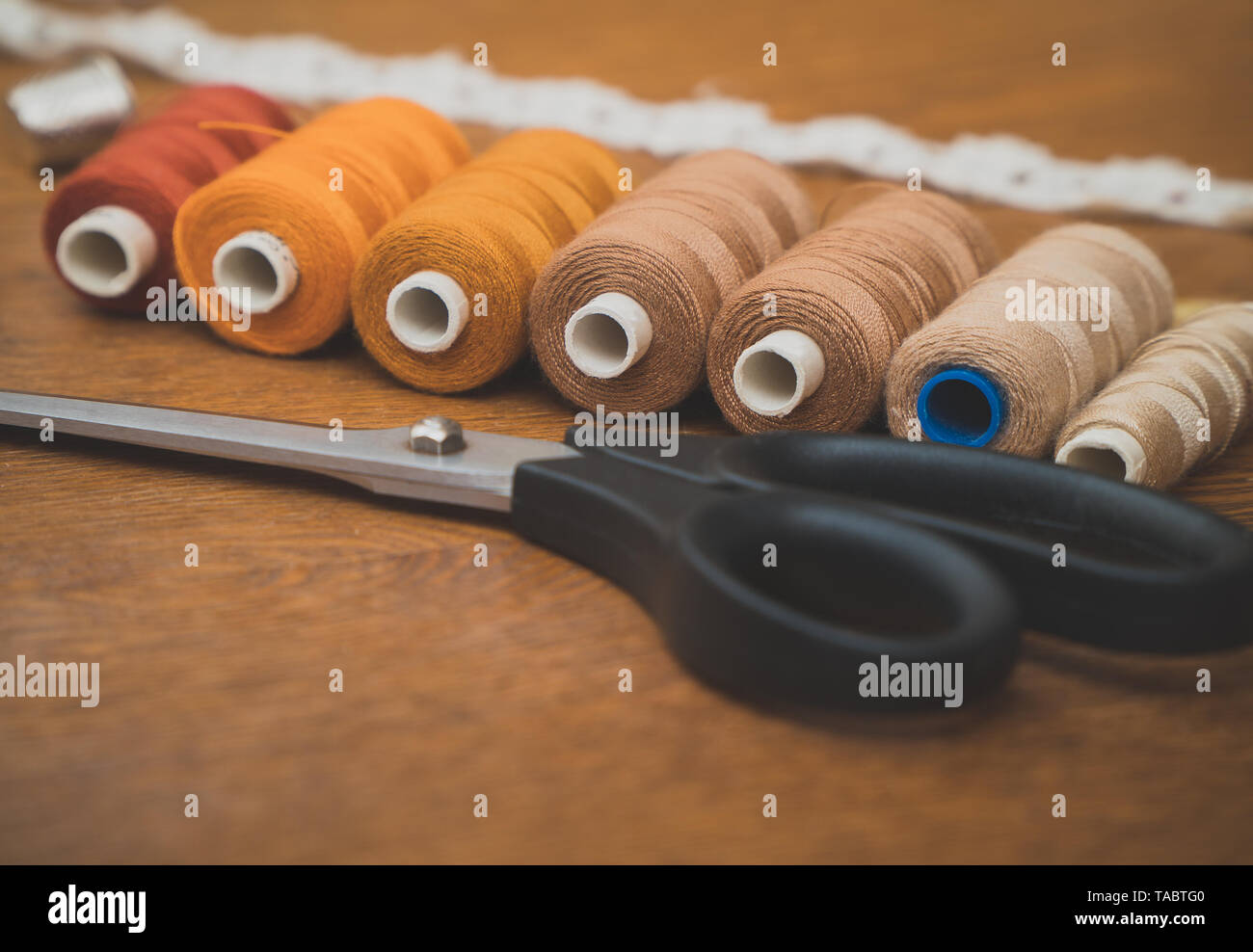 Sewing concept. Scissors and thread spools Stock Photo - Alamy