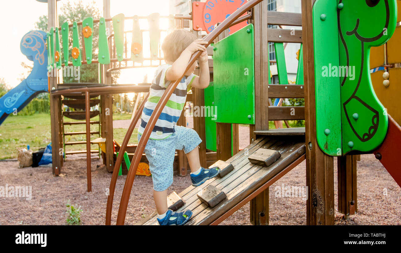 3 children climbing ladder hi-res stock photography and images - Alamy