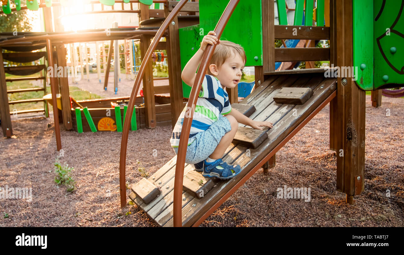 3 children climbing ladder hi-res stock photography and images - Alamy