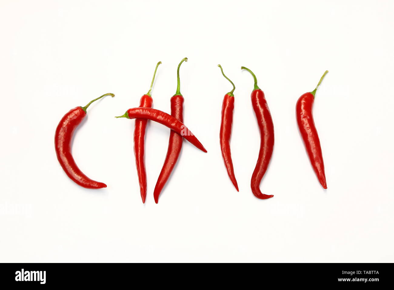 Red chili on paper white background Stock Photo - Alamy