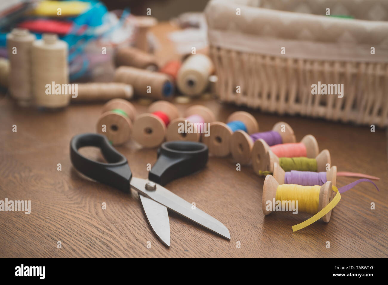 Sewing concept. Scissors and colorful thread spools Stock Photo - Alamy
