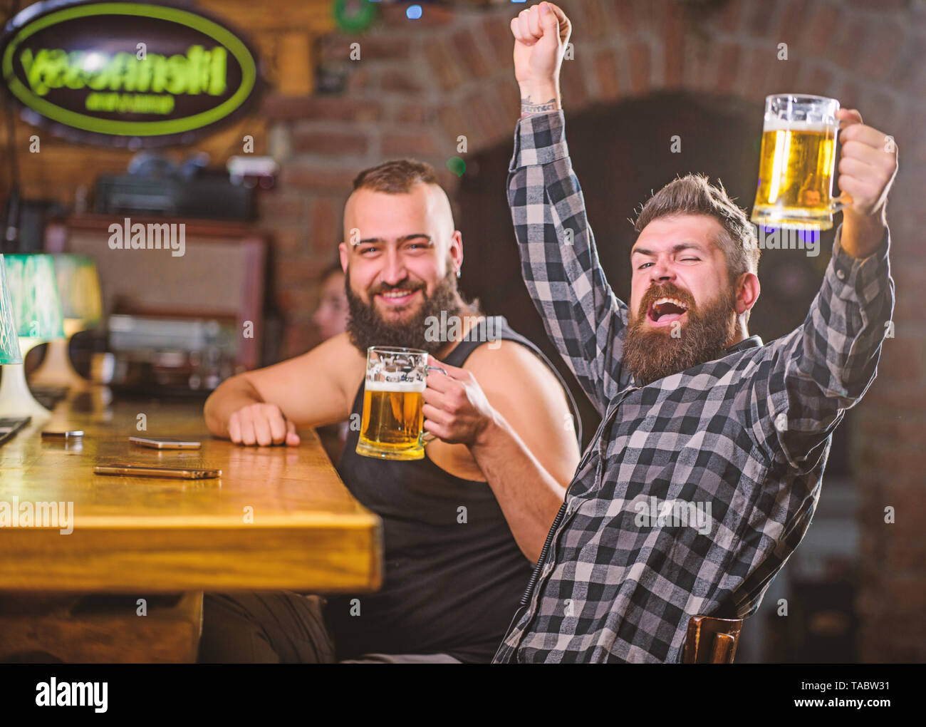 Refreshing beer concept. Hipster brutal man drinking beer with friend ...