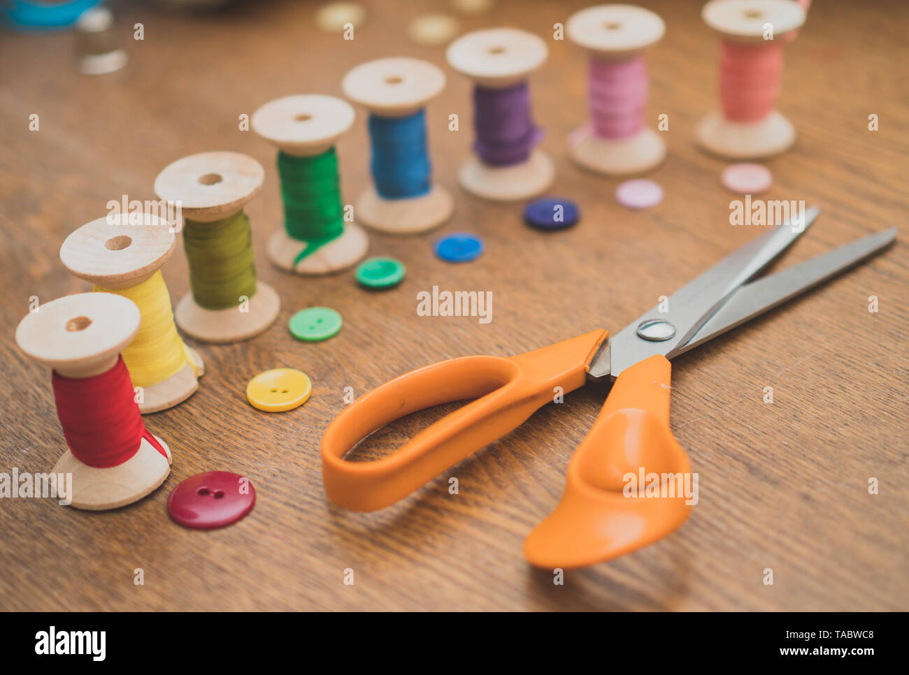 Sewing concept. Scissors and colorful thread spools Stock Photo - Alamy
