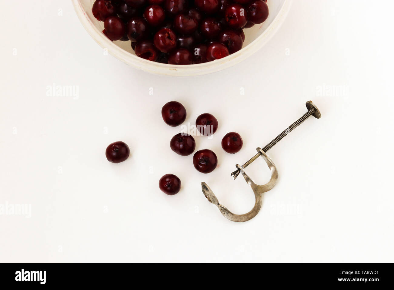 A pitted cherry is located in a bowl on a white background, Removal of ...