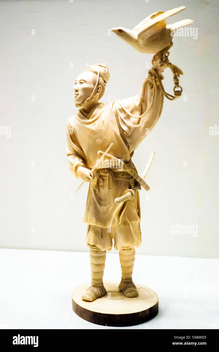A nobleman's retainer carrying a hawk, around 1880-1900 carved ivory ...