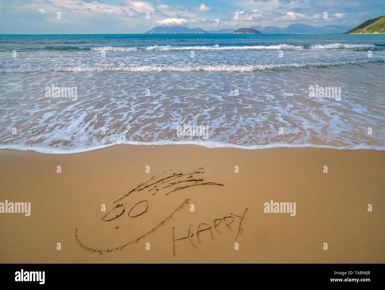 Smiley face in sand hi-res stock photography and images - Alamy