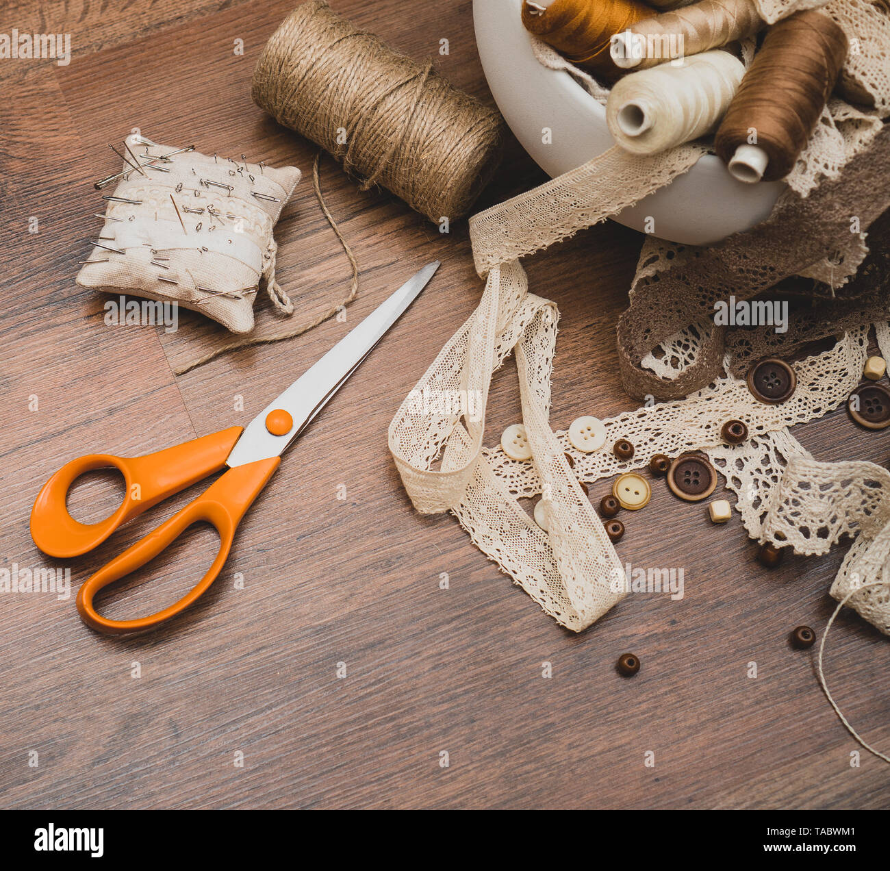 Sewing concept. Scissors, thread spools, buttons and sewing needles ...