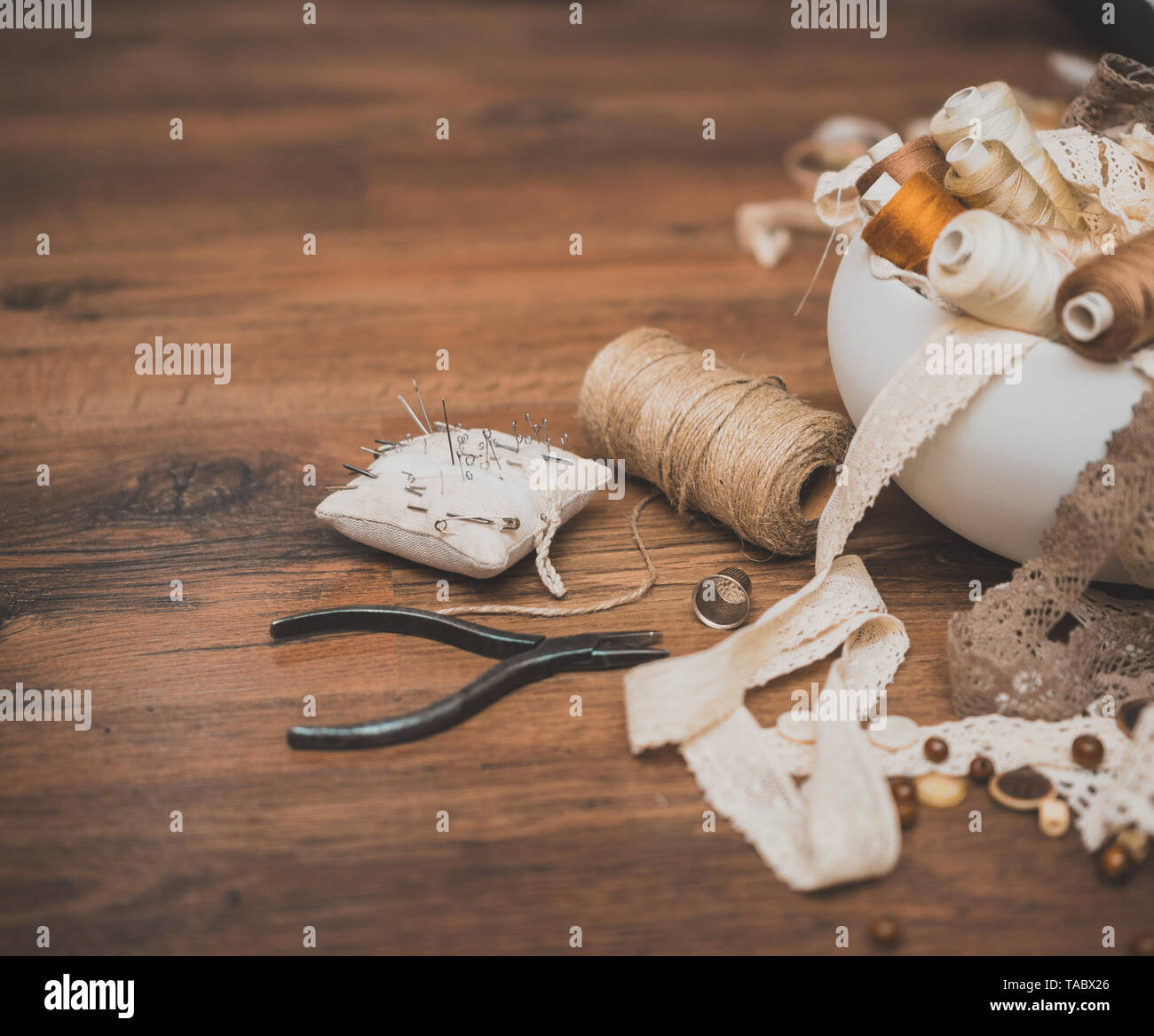 Sewing concept. Thread spools, buttons and sewing needles Stock Photo ...