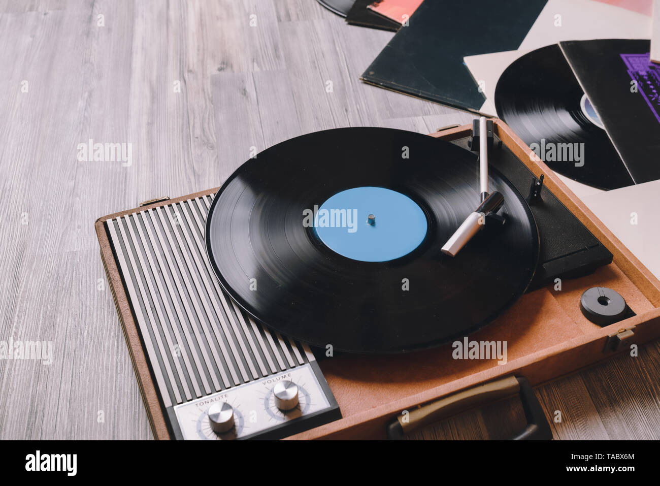 Vintage Gramophone with a vinyl record on gray wooden table, top view ...