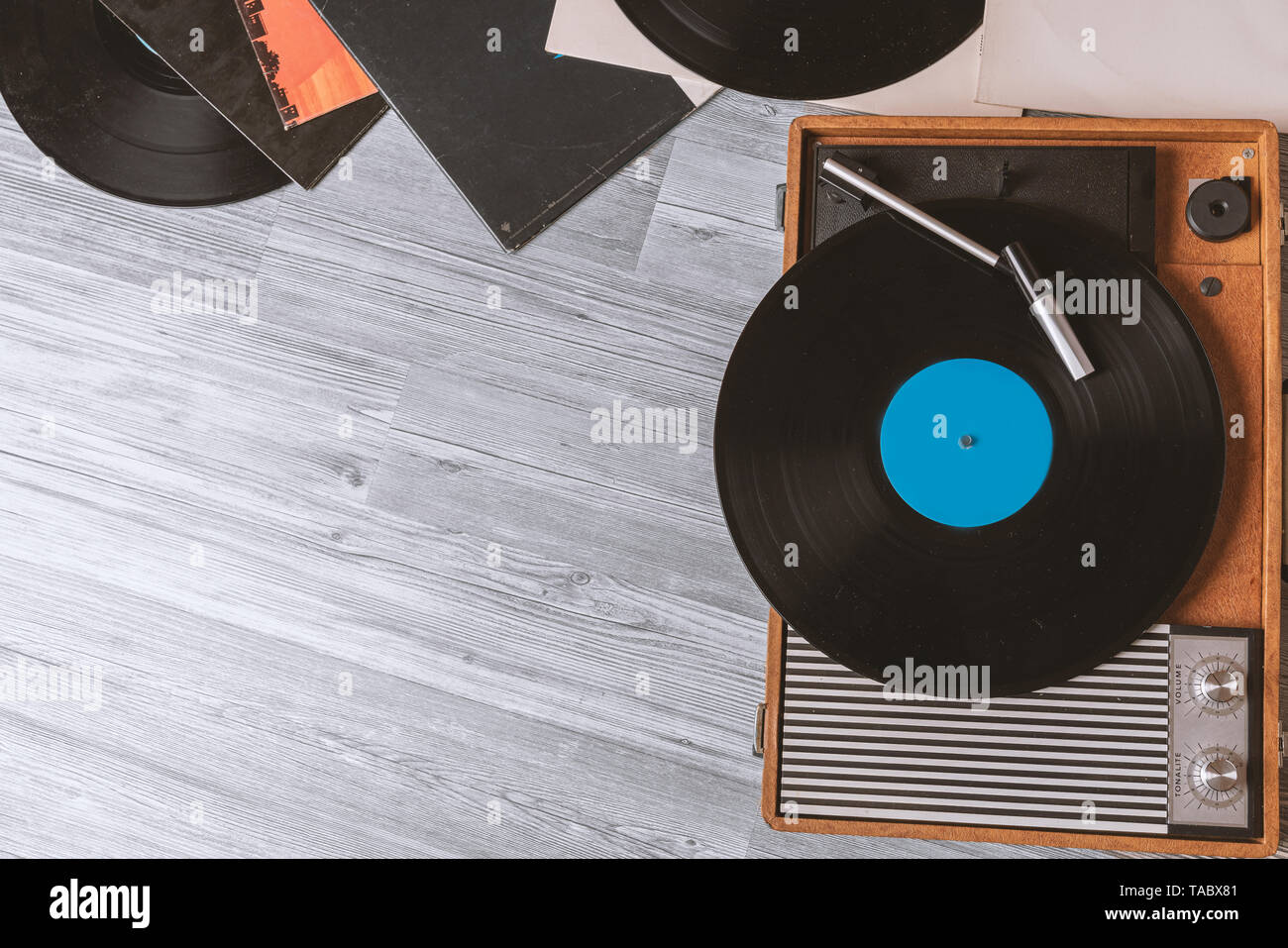 Vintage Gramophone with a vinyl record on gray wooden table, top view ...