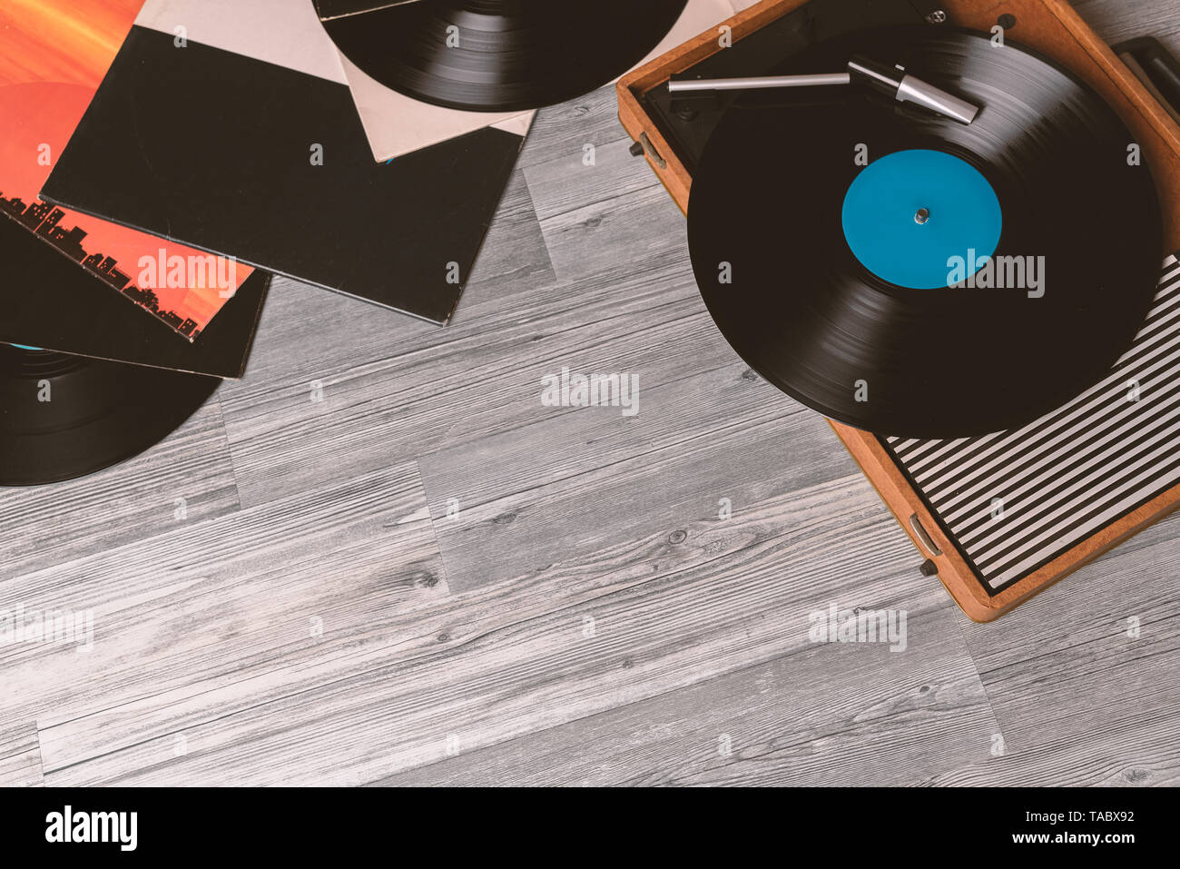 Vintage Gramophone with a vinyl record on gray wooden table, top view ...