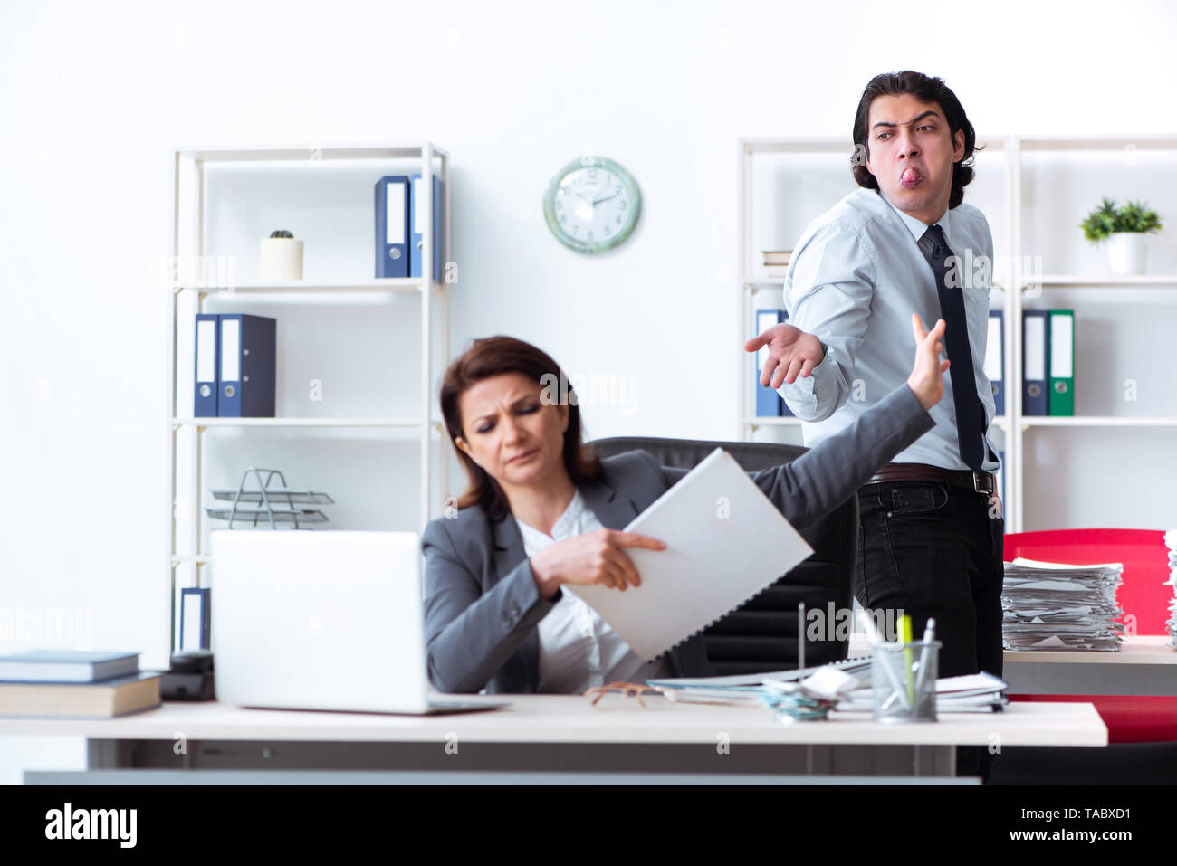 Old female boss and young male employee in the office Stock Photo - Alamy