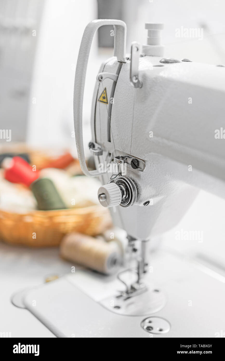 Sewing concept. Sewing machine and spool threads Stock Photo - Alamy