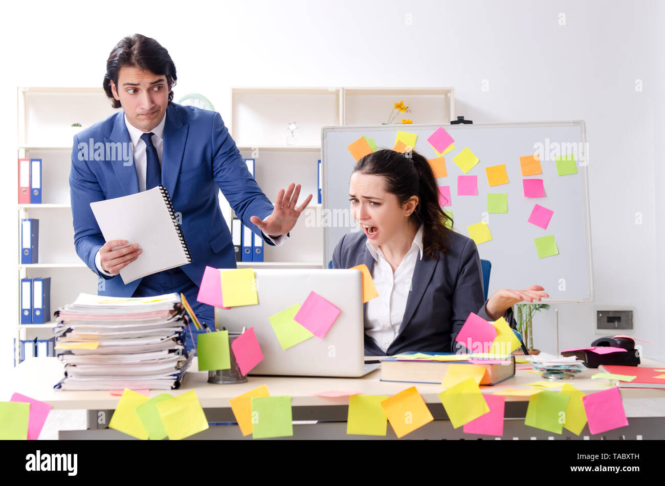 Two colleagues employees working in the office Stock Photo - Alamy