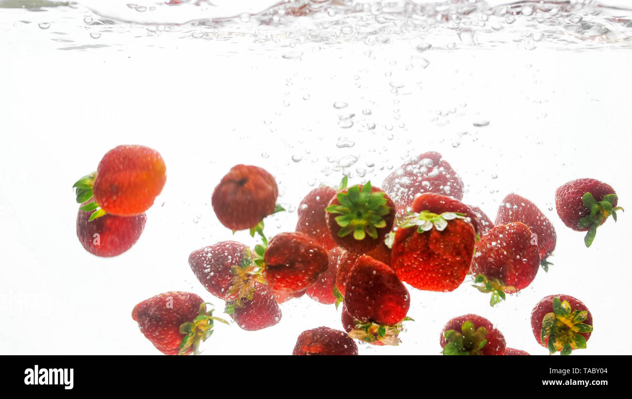 Closeup isolated image of lots of fresh ripe raspberries falling and ...