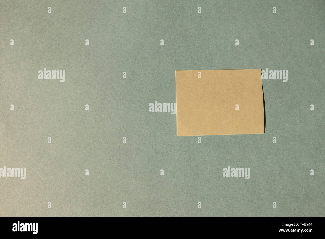 attached yellow note with free text blue background Stock Photo - Alamy