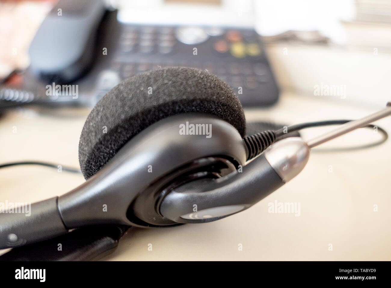 Headset with telephone in the background in the office on the desk ...