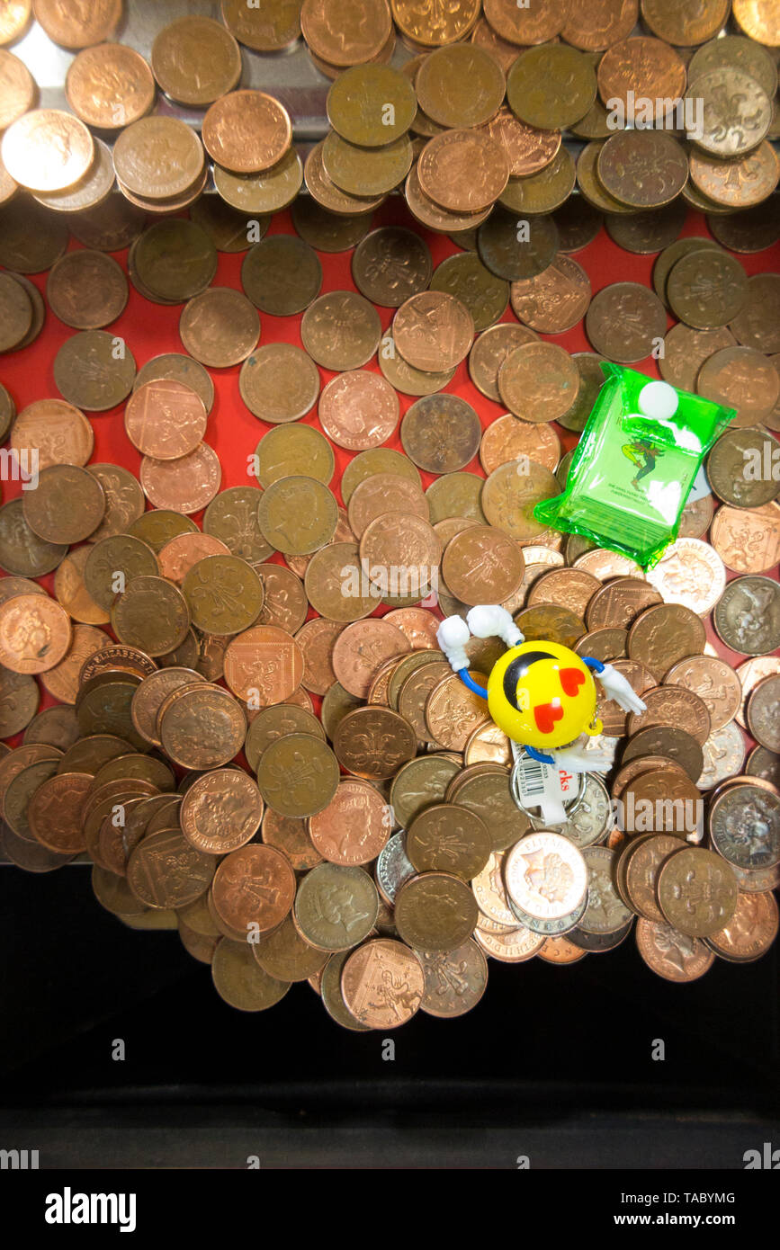 Two pence 2p coins waiting to fall and be won ( or lost and go to the ...