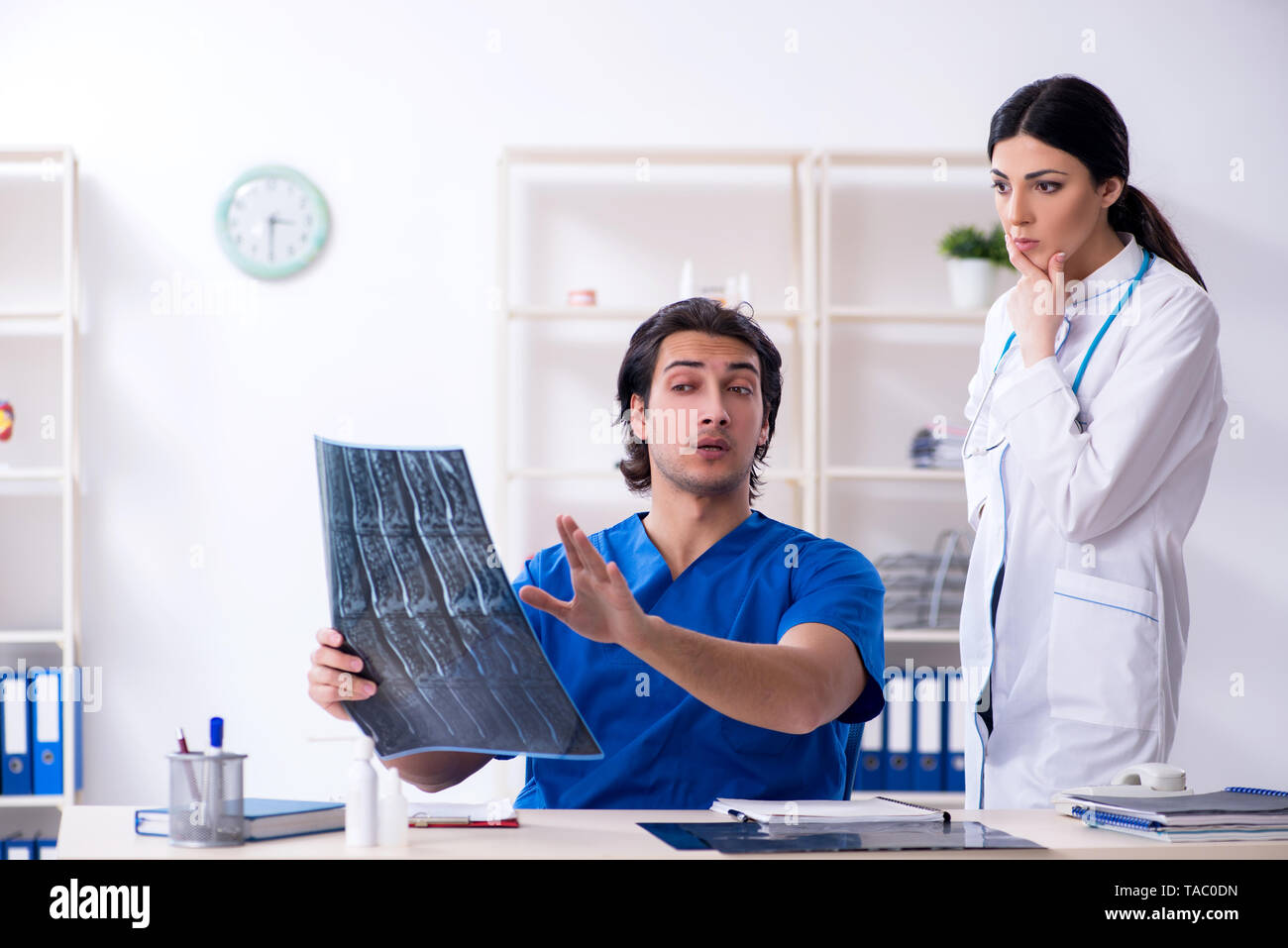 Two young doctors working in the clinic Stock Photo - Alamy
